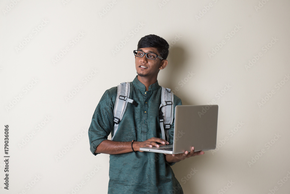 teenage indian male in traditional dress with laptop Stock Photo ...