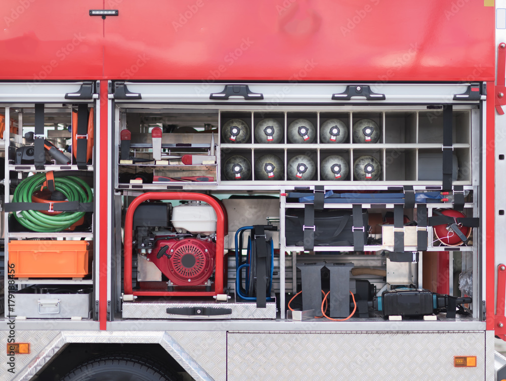 Compartment of rolled up fire hoses on a fire engine. Rescue fire truck ...