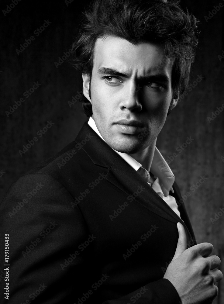 Confident ambitious handsome man with strained look posing in fashion ...