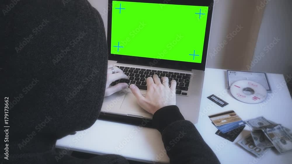 Hooded Person Typing On Laptop In a Crime Scene, Pan Movement. Hooded ...