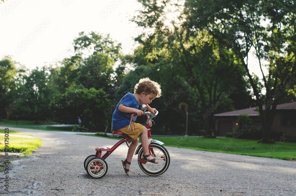 Boy on Tricycle Stock Photo | Adobe Stock