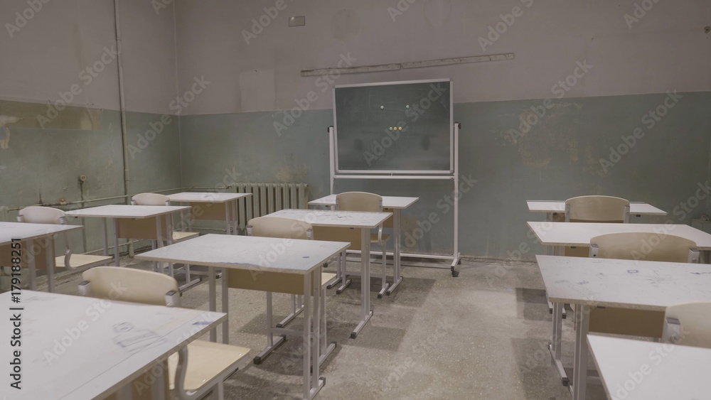 Empty classroom with wooden desks, white and green chalk boards in ...
