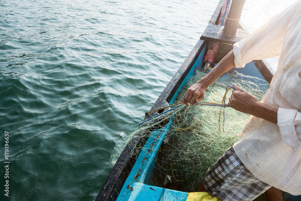 fisherman pulling his net out of the water Stock Photo | Adobe Stock