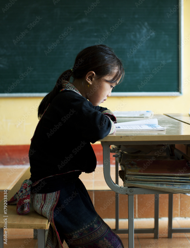 Young girl from Hmong tribe, studying alone in classroom. Sapa. Stock ...