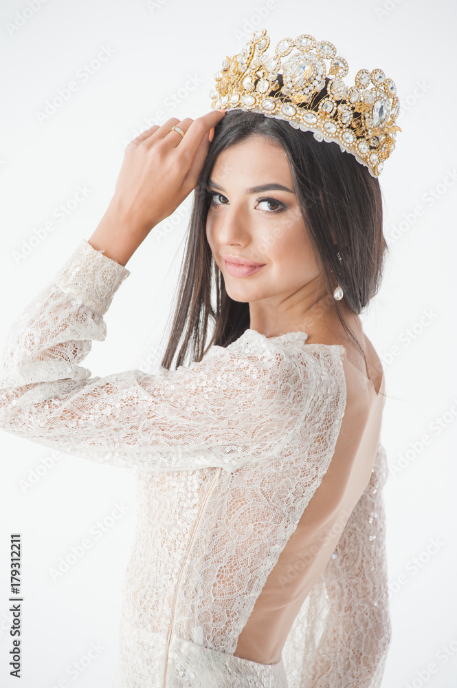 charming winner of the Miss contest, in a white dress and crown Stock ...