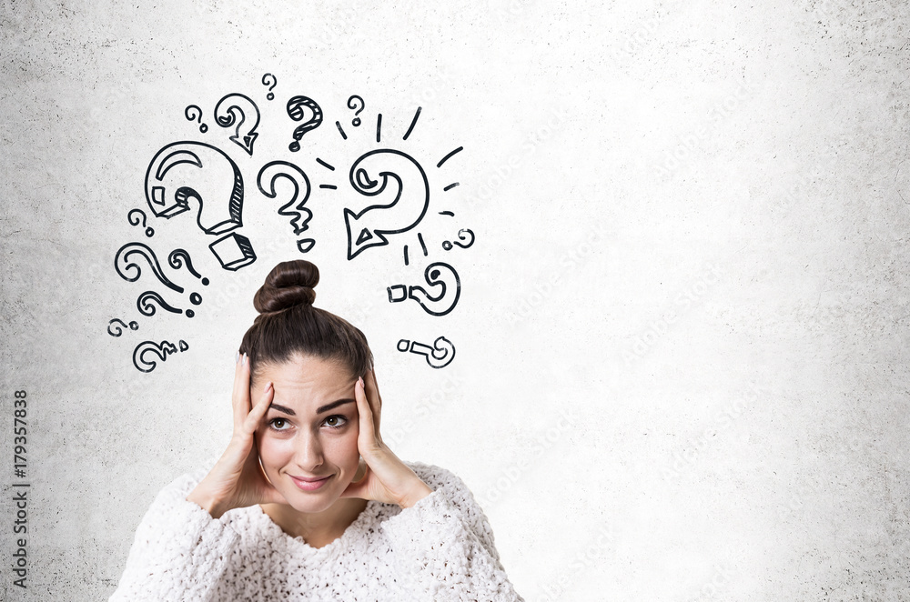 Stressed young woman with a bun, question marks Stock Photo | Adobe Stock