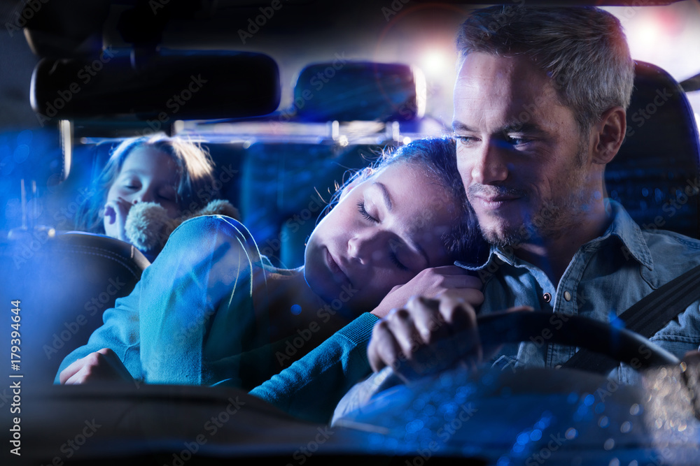 family by car at night, Dad drives. Mom and daughter fell asleep Stock ...