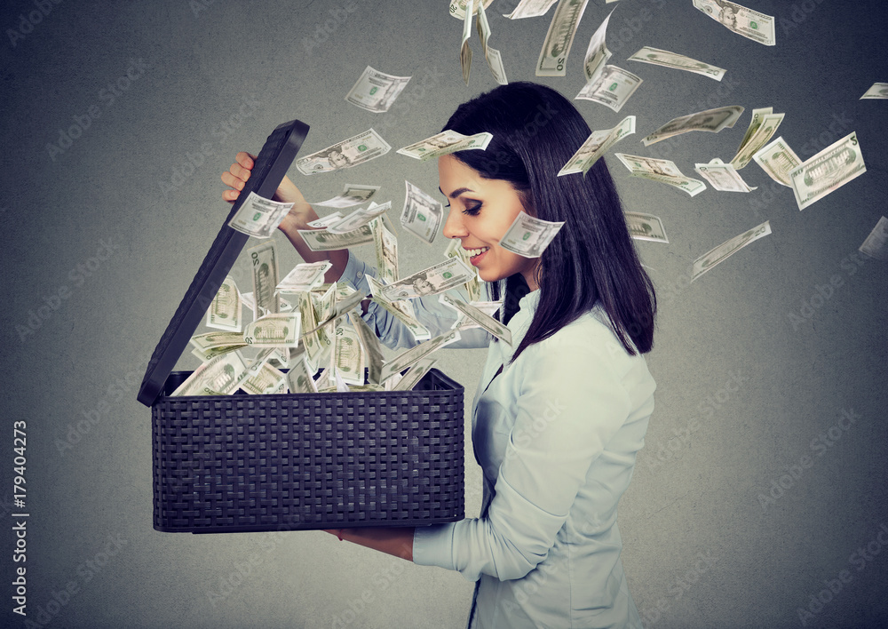 Happy woman opening a box with money flying out away Stock Photo ...