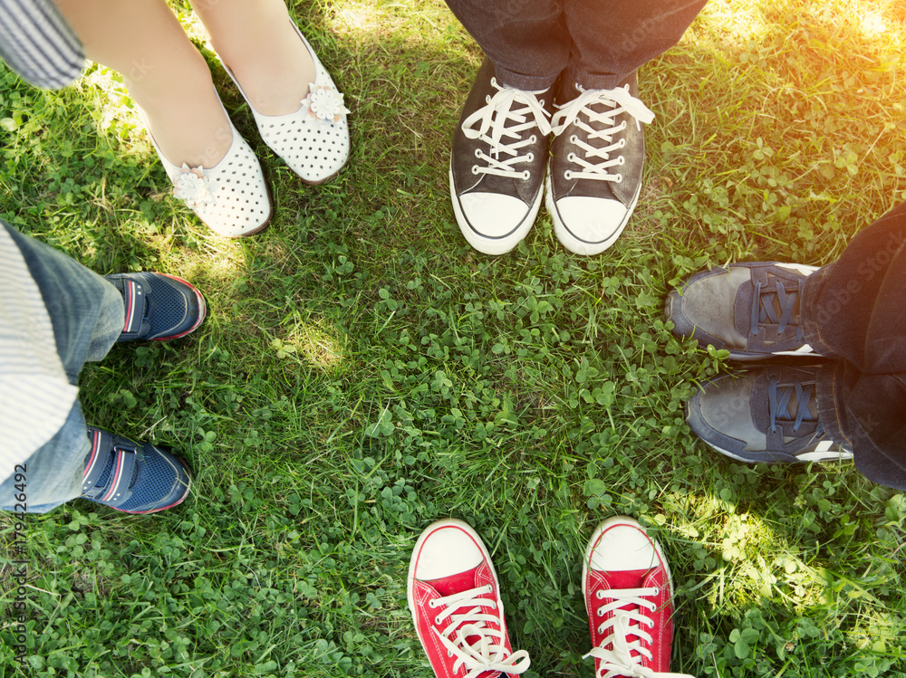 Family in nature. Feet of mother, father, child, grandmother and ...