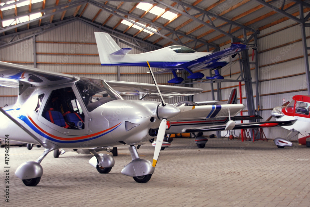 Small private lightweight propeller airplanes in hangar. Stock Photo ...