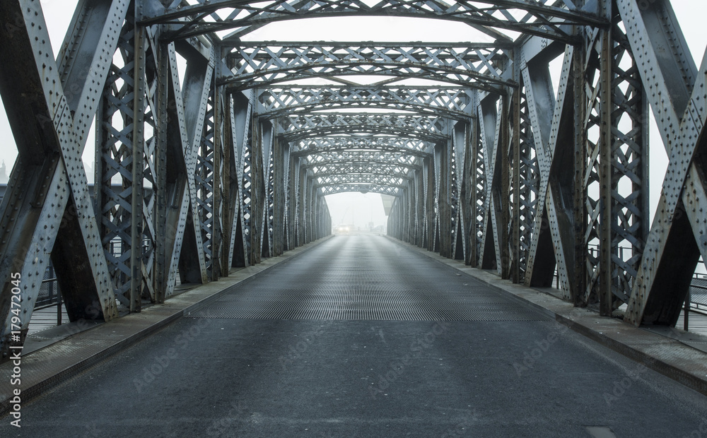 Metal construction of the city bridge on a foggy day in Dieppe, France ...