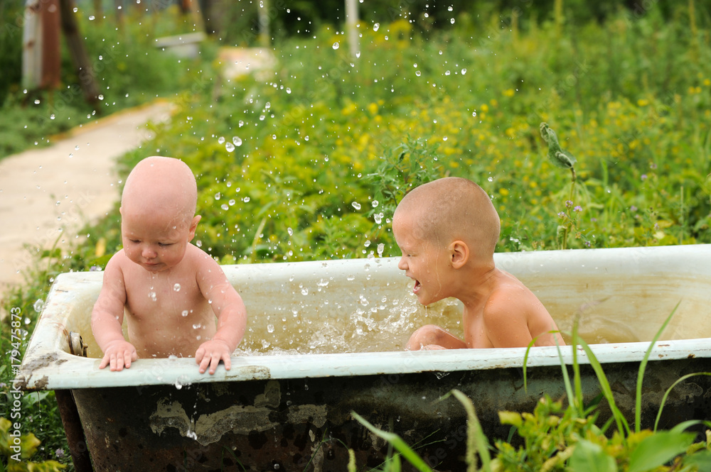 Boys are bathing in the bathroom in the fresh air. Bathing in the ...