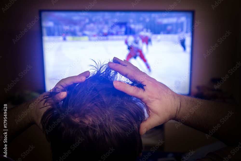 Back view of excitement man with gesturing hands up how watching ice ...