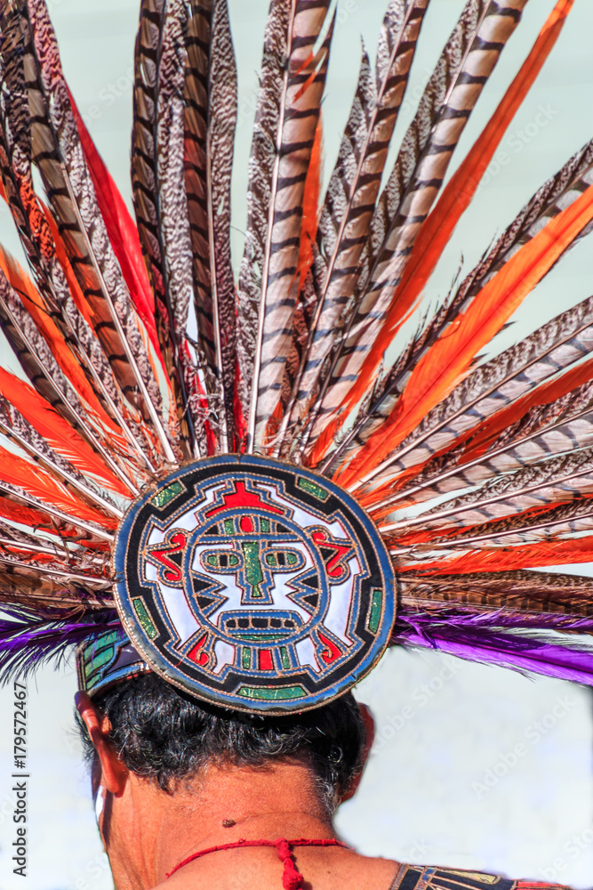 Aztec feathered headdress worn by a dancer. A close rear view with the ...