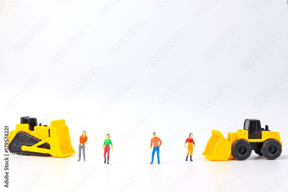 Under construction concept, with group of human toy and heavy duty ...