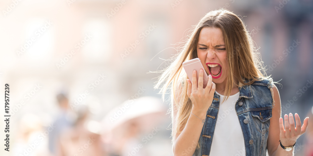 Angry and upset teenager screaming at the mobile telephone Stock Photo ...