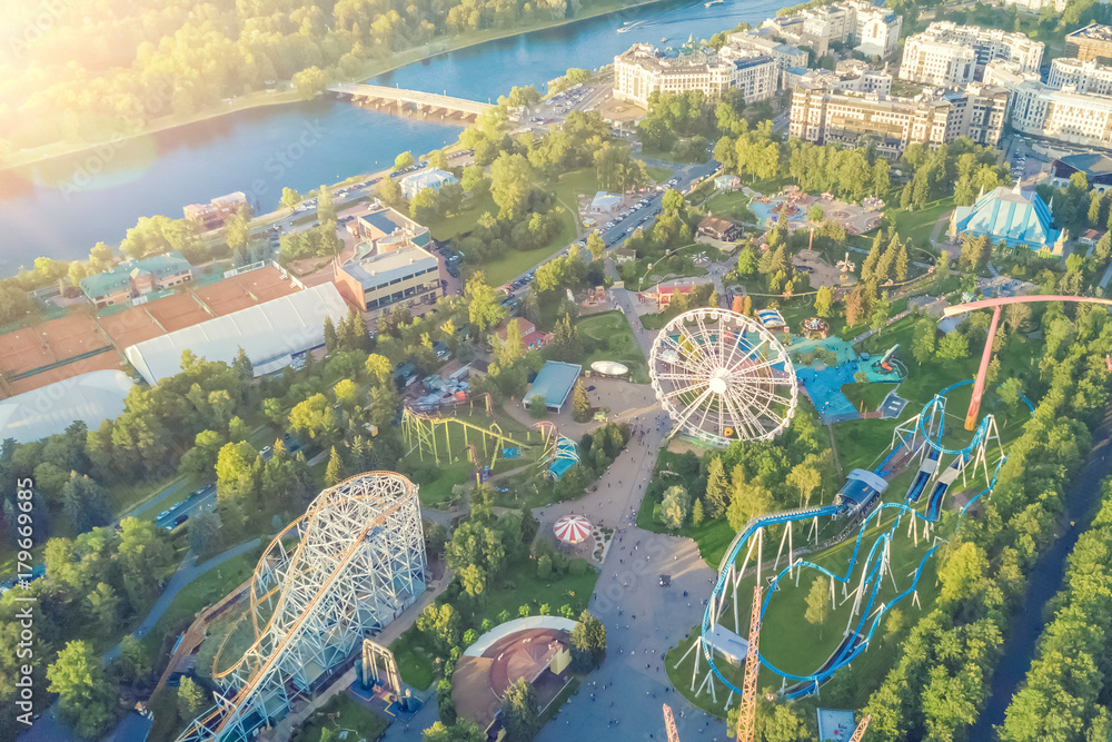 Top view of the amusement park with a ferris wheel and roller coaster ...