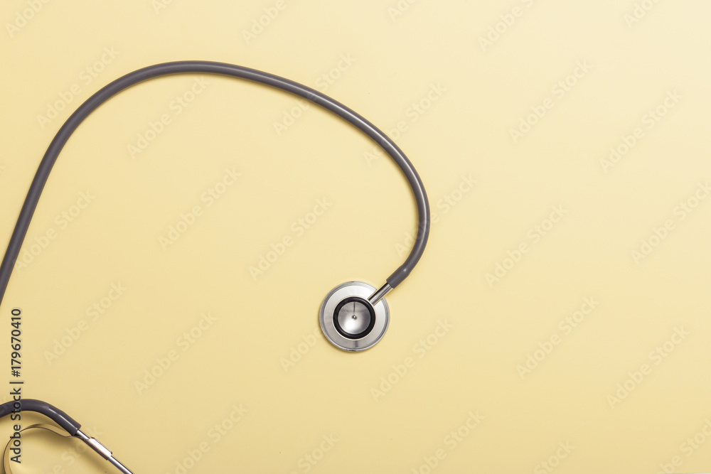 stethoscope on the yellow color paper background. Stock Photo | Adobe Stock