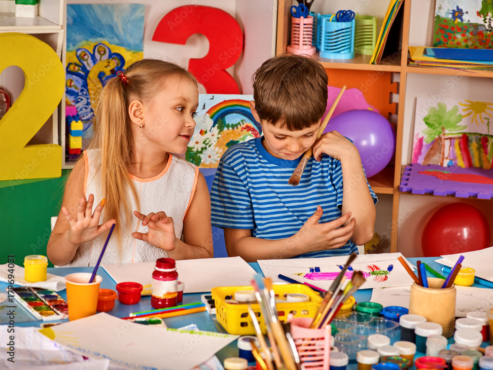 Small students painting in art school class. Children boy and girl ...