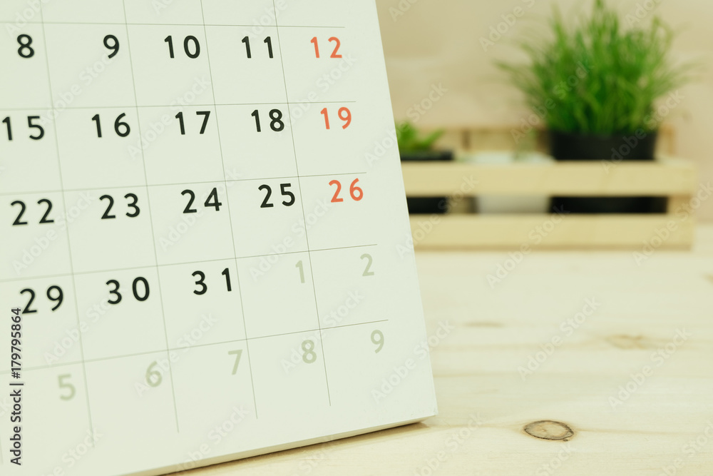 calendar placed on wooden table has ornamental plants in wood basket ...