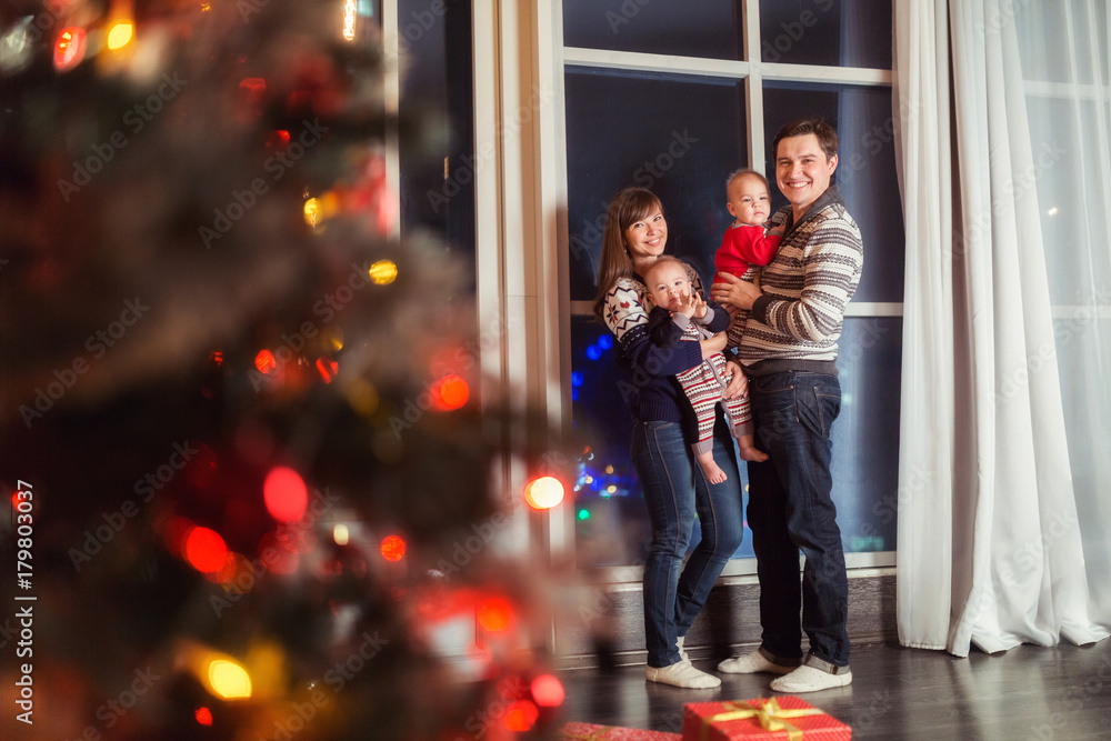 Christmas 2018. Happy family with presents and gifts near a big window ...