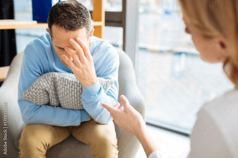 My depression. Depressed gloomy cheerless man holding his forehead and ...