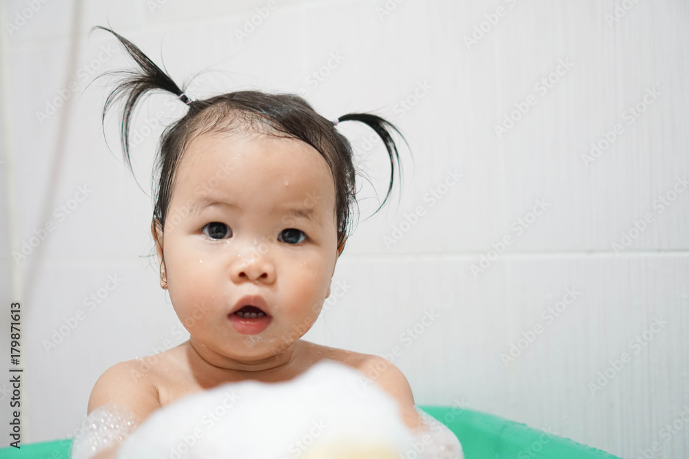 Little asian girl taking bath foam bubbles in bathtub, Toddler 1.8 ...