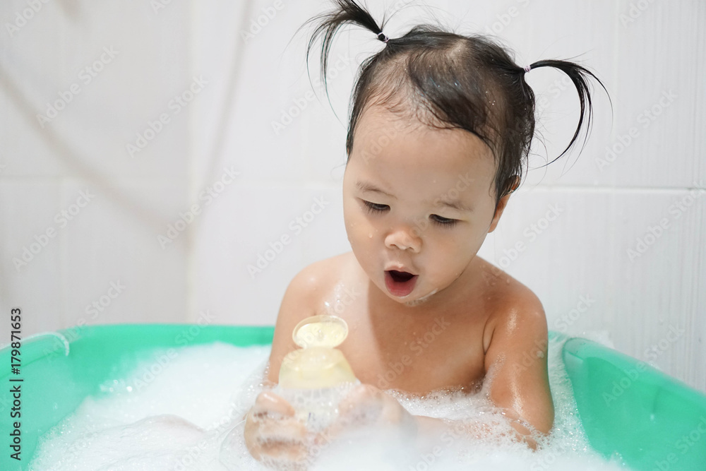 Little asian girl taking bath foam bubbles in bathtub, Toddler 1.8 ...