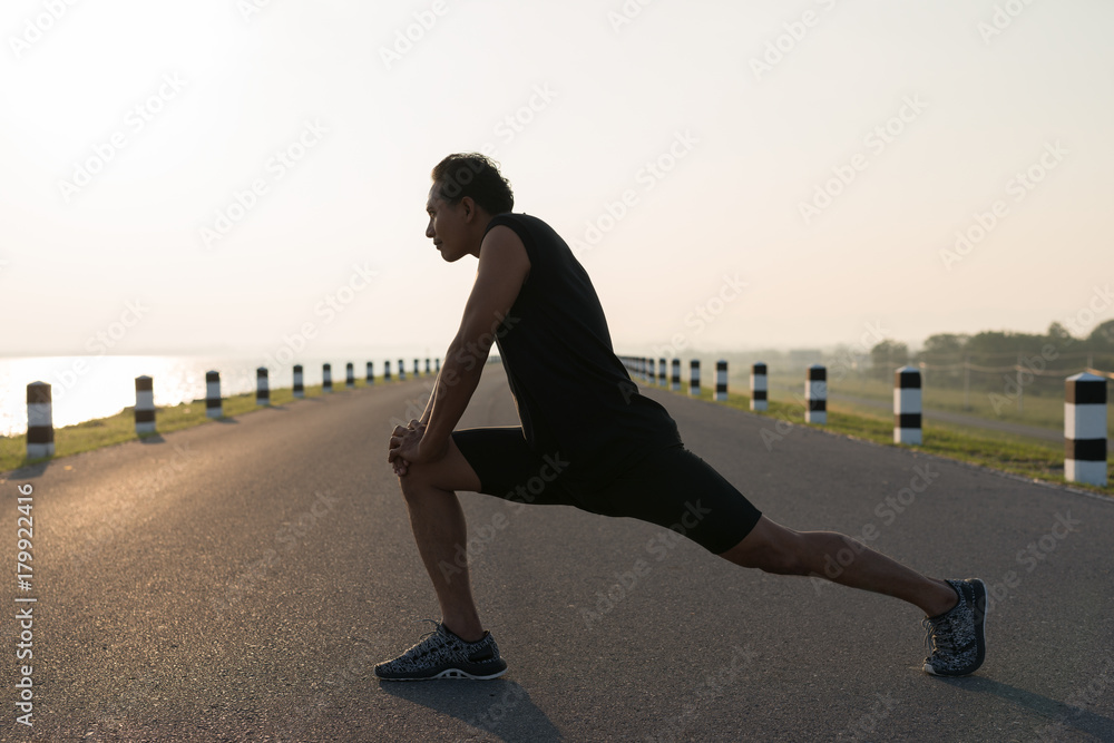 Asia young man runner doing stretching exercise, preparing for running ...