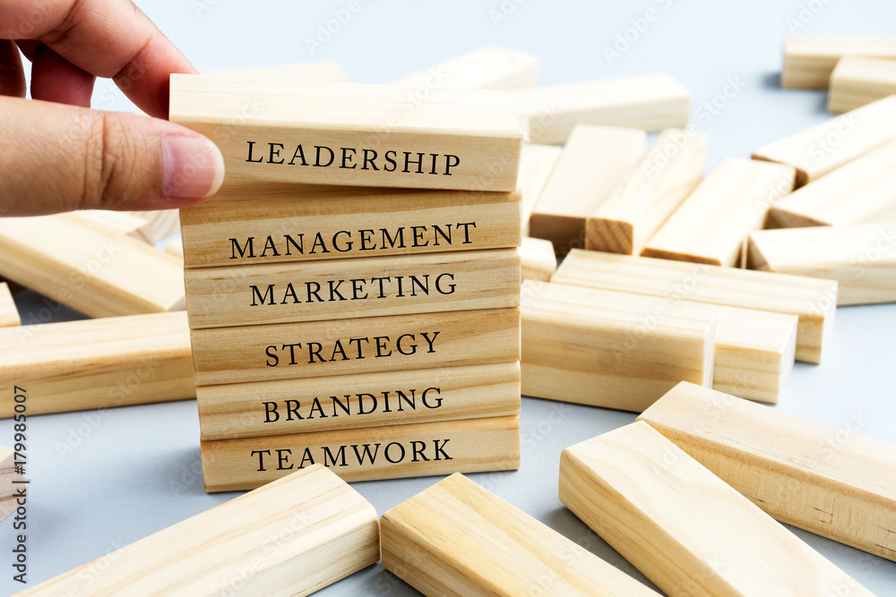 Hand Picking Wood Block with Word Leadership. Business Concept - Wood ...