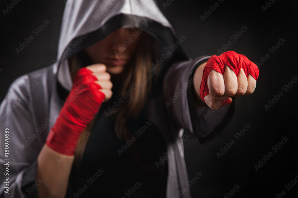 Female boxer makes a fight with a shadow, striking with silver boxing ...