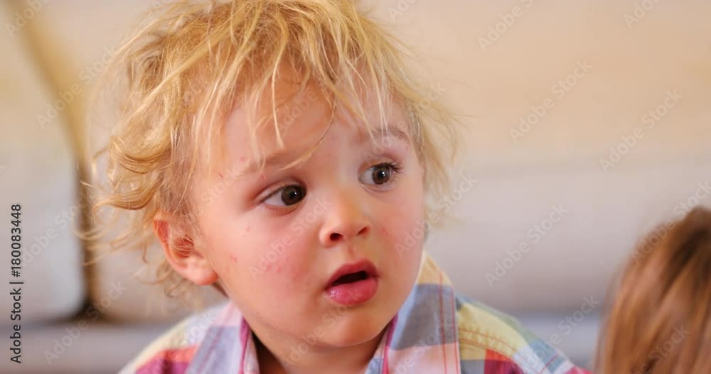 Infant toddler baby boy acting surprised by what he is watching on TV ...