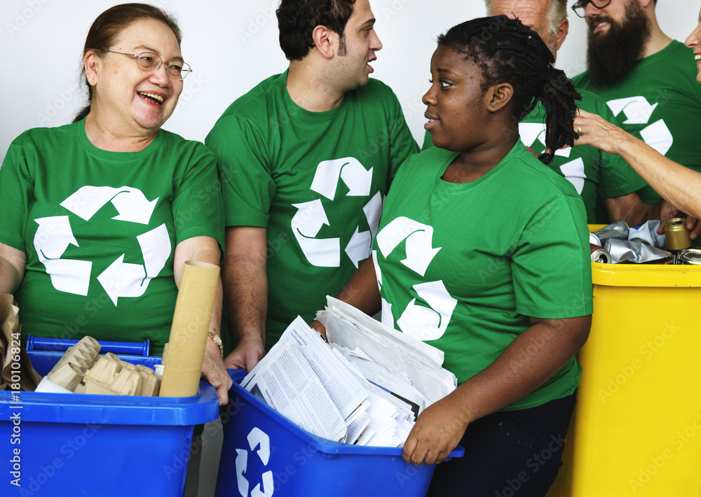 People in group wearing recycle icon shirts and posing for photoshoot ...
