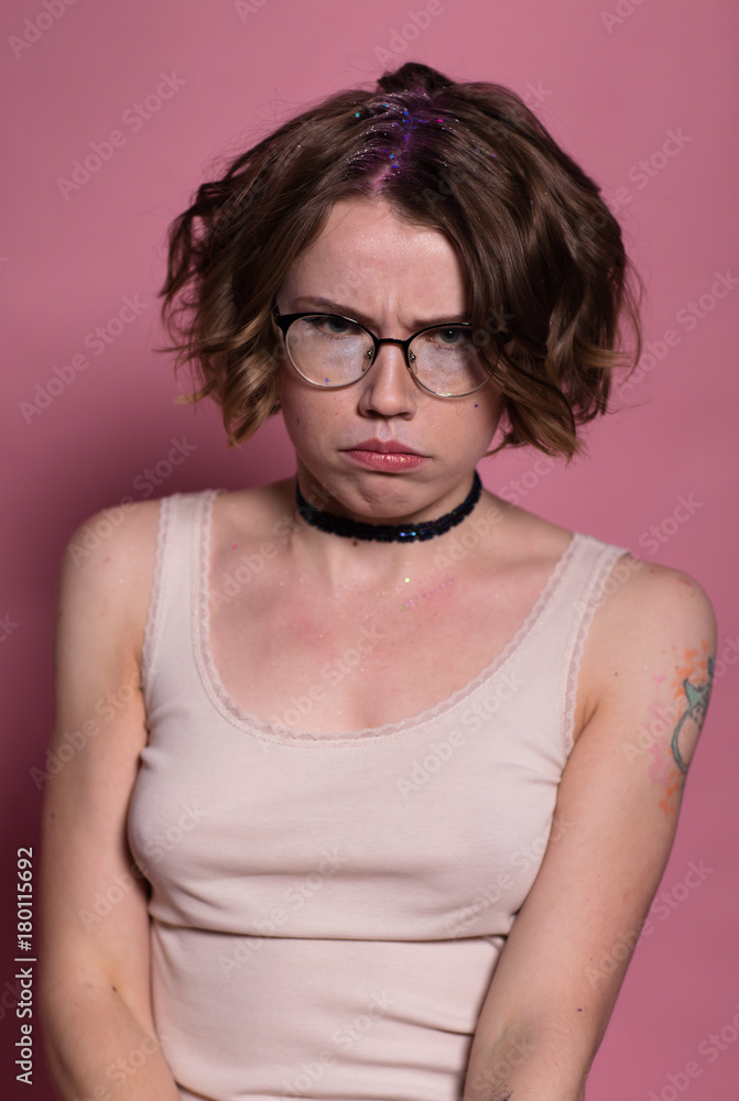 Portrait of attractive girl in eyeglasses. Serious aggressive face ...