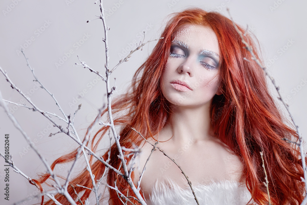 Redhead girl with long hair, a face covered with snow with frost. White ...