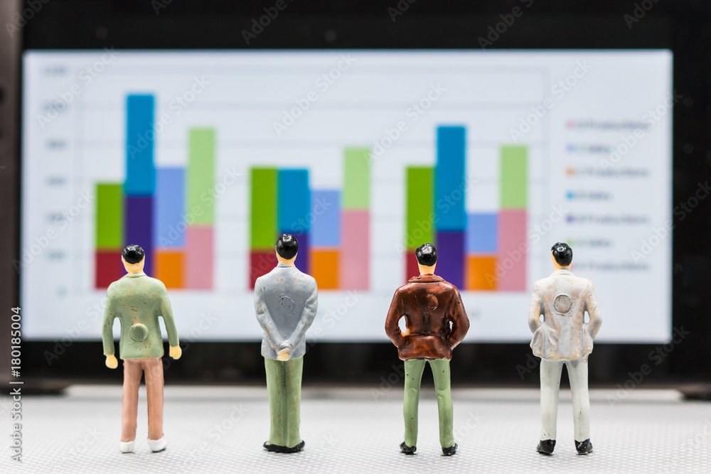 Miniature people : small figures businessmen stand with graph on the ...