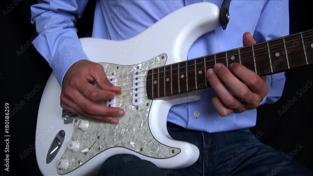 Close up of a man practicing chords with guitar, young man playing the ...
