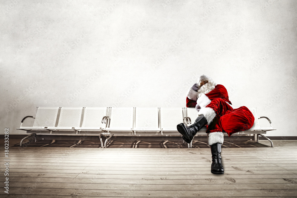 Old red santa claus siting on chairs. White wall background for your ...