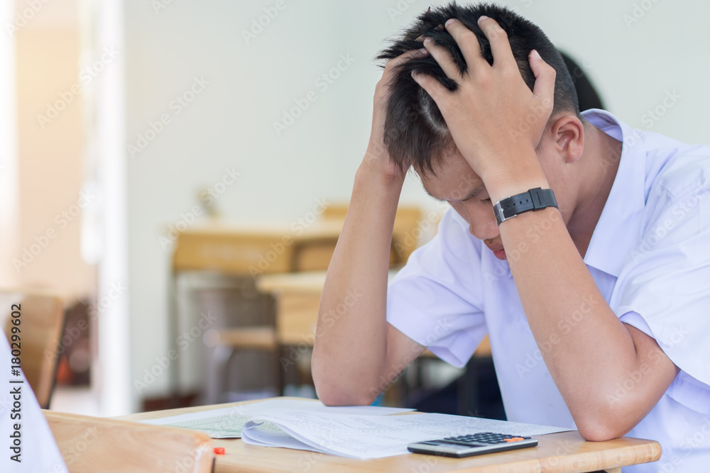 Asian boy student studying stressed headaches for test or exams in ...