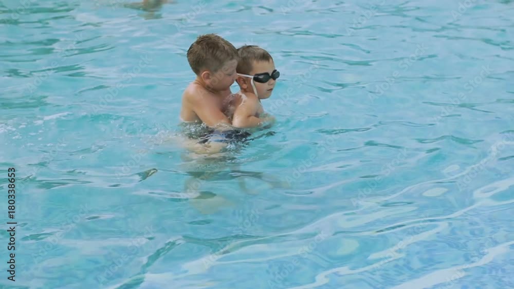 Older brother teaches a younger brother wearing swimming glasses to ...