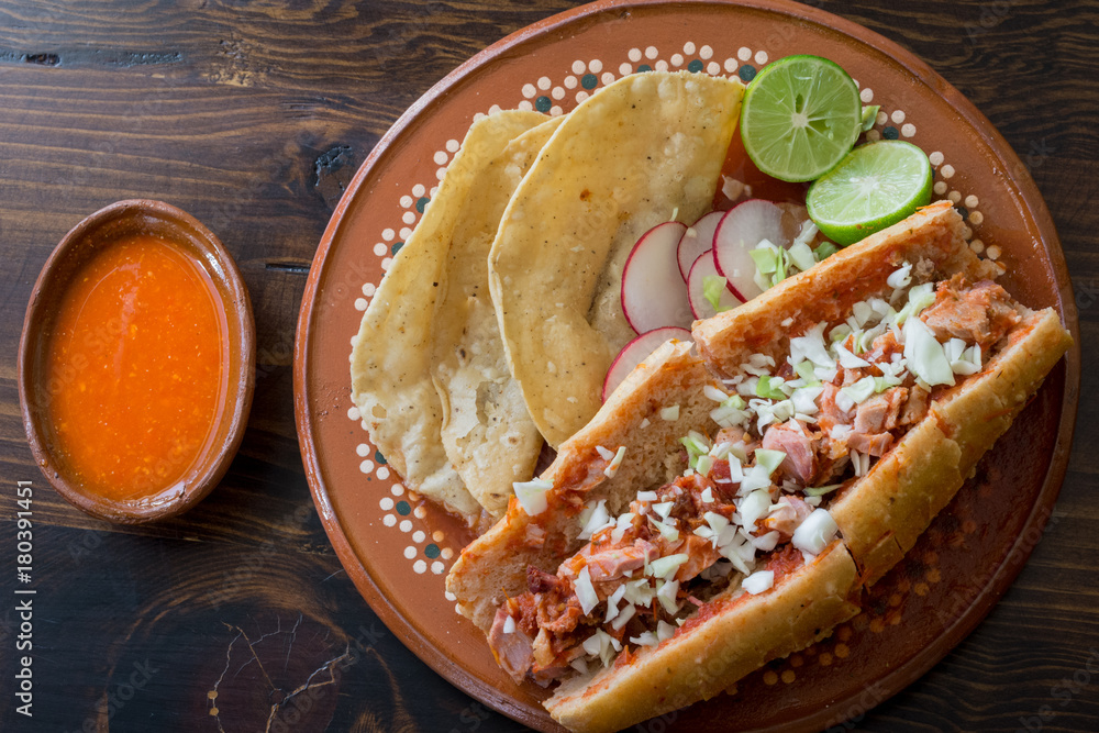 Authentic Mexican torta ahogada pork meat sandwich soaked in hot tomato ...