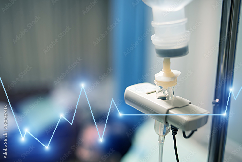 Close up saline solution drip for patient and infusion pump in hospital ...