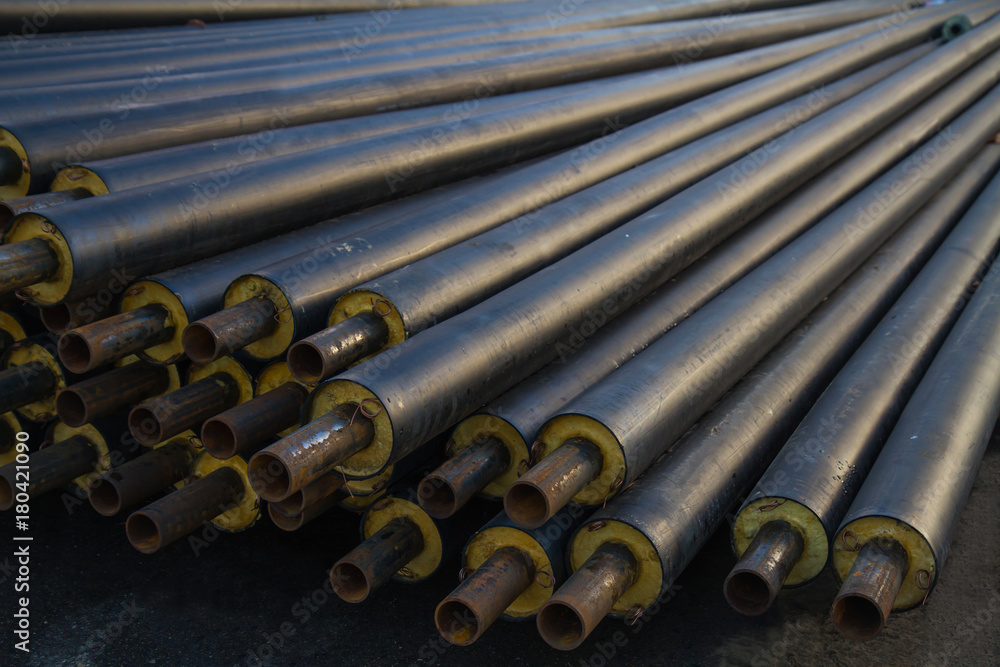 black steel pipe with heat insulation on the construction site in a ...
