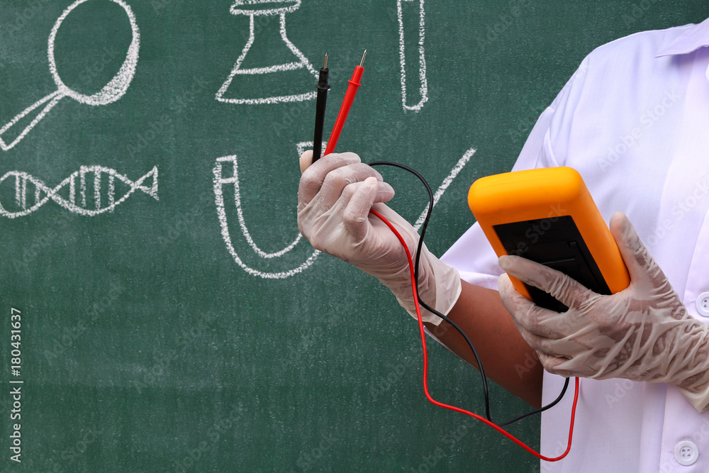 Scientists hold Analog Multimeters in hands to teach students on campus ...