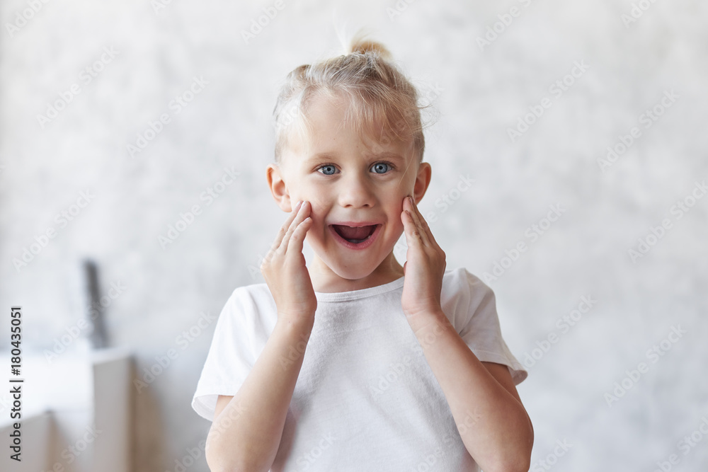 Portrait of delightful adorable 5 year old male child opening mouth in ...