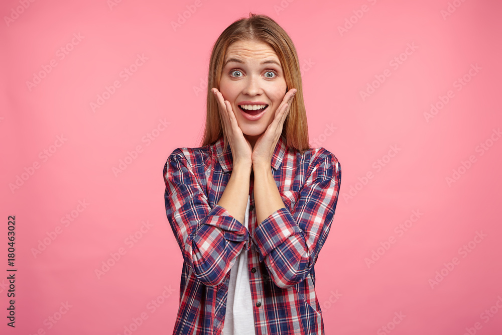 Beautiful amazed woman can`t believe her eyes, glad to recieve ...