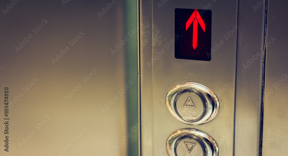 elevator button up and down and a screen that shows a red arrow up ...