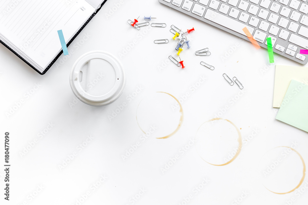 Clutter in office. Desk covered with crumpled paper and coffee stains ...