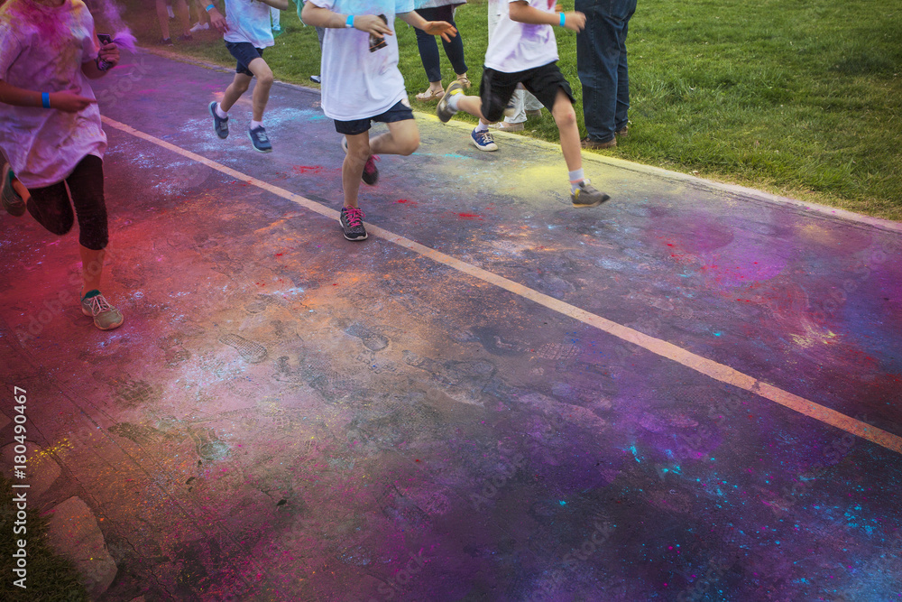 Abstract photo of a group of runners running in a color run race event ...