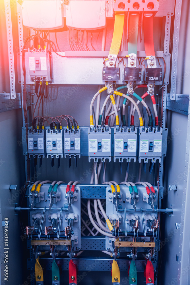 Wires and switches in electric box. Electrical panel with fuses and ...